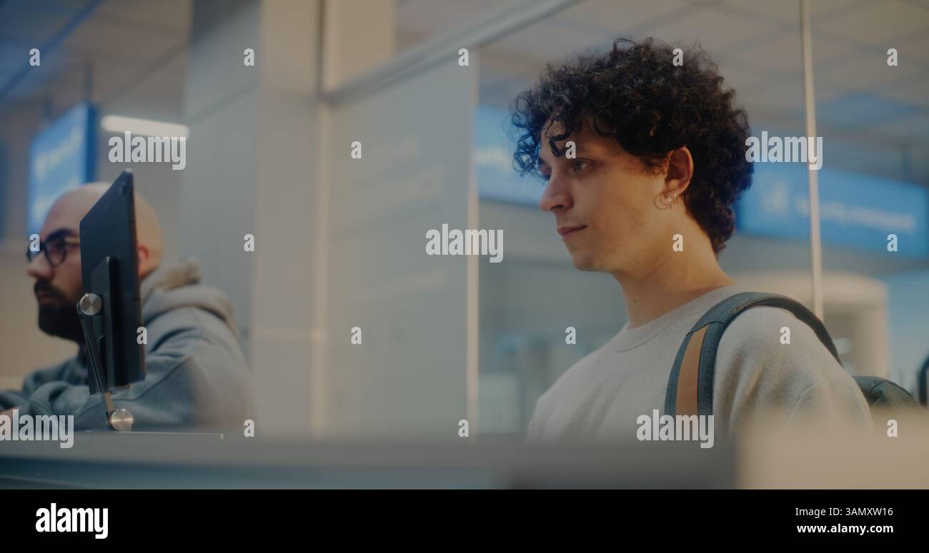 Diverse Passengers at Airport Check-in Counter: Young Man Verifying ...