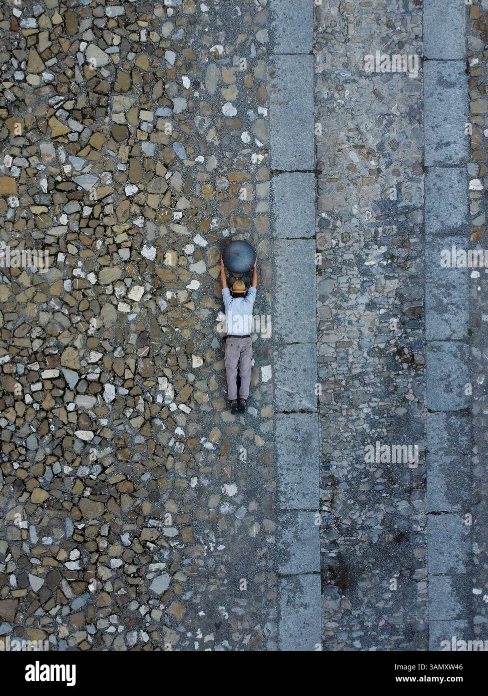 Aerial view of a person laying down on the ground fixed at one point ...