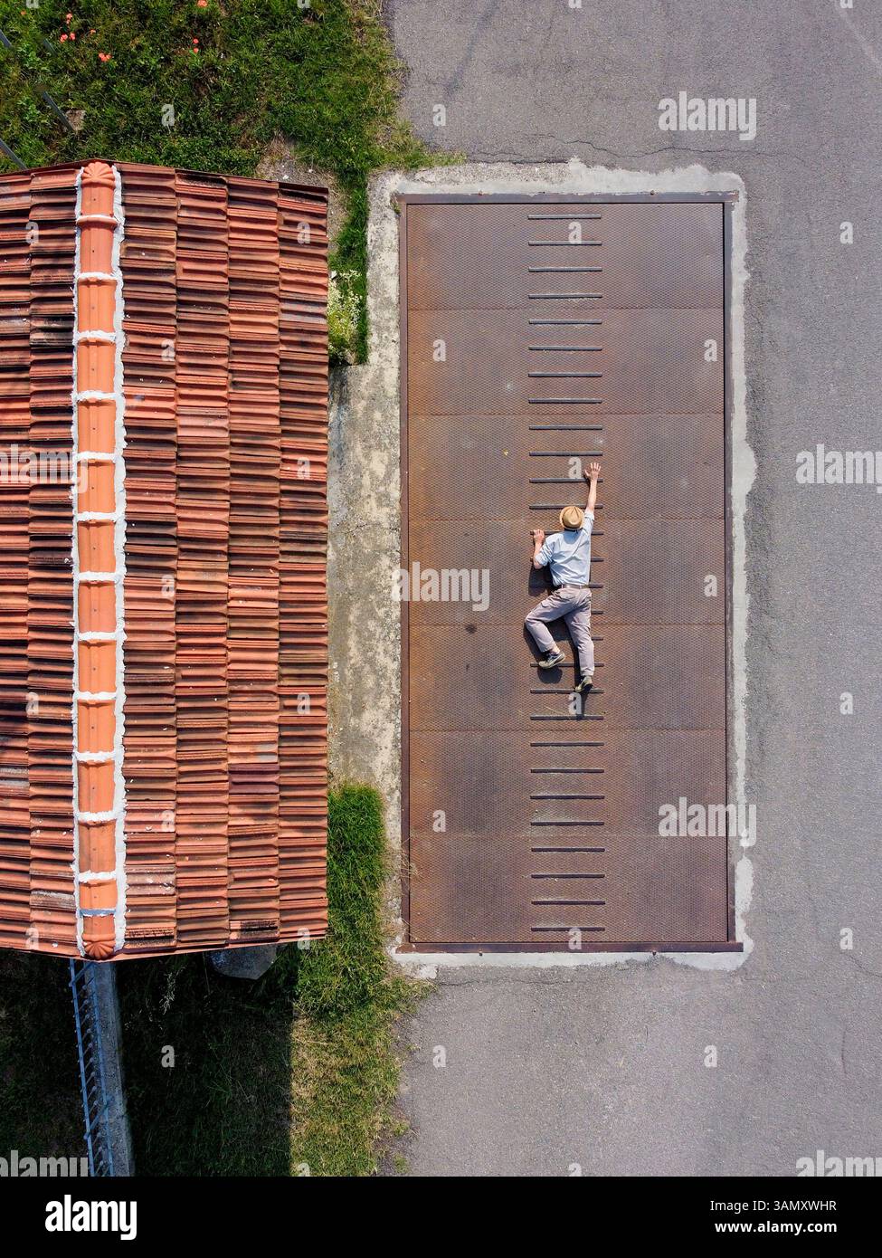 Aerial view of a person laying down on the ground climbing an old ...