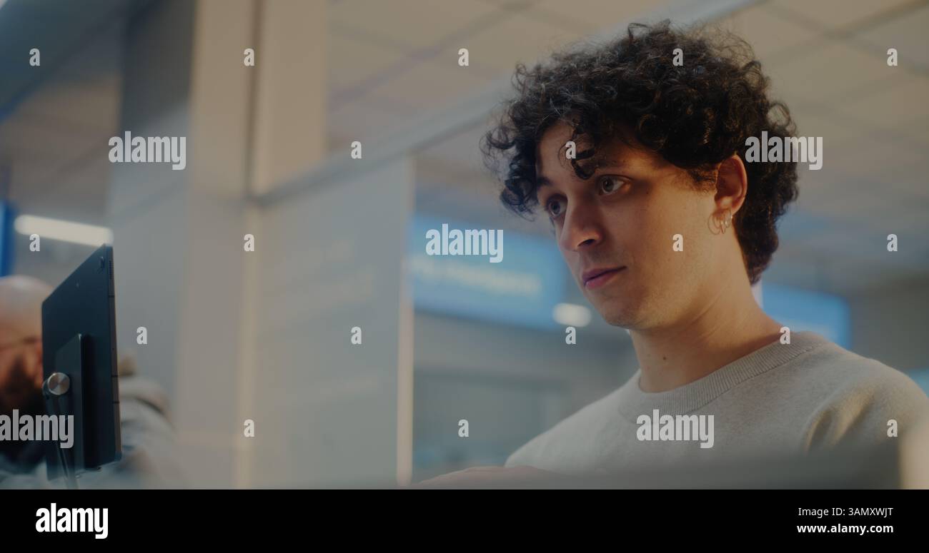 Diverse Passengers at Airport Check-in Counter: Young Man Verifying ...