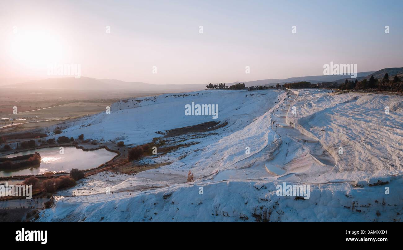 Aerial view of white cotton castle at sunset with travertine terraces ...