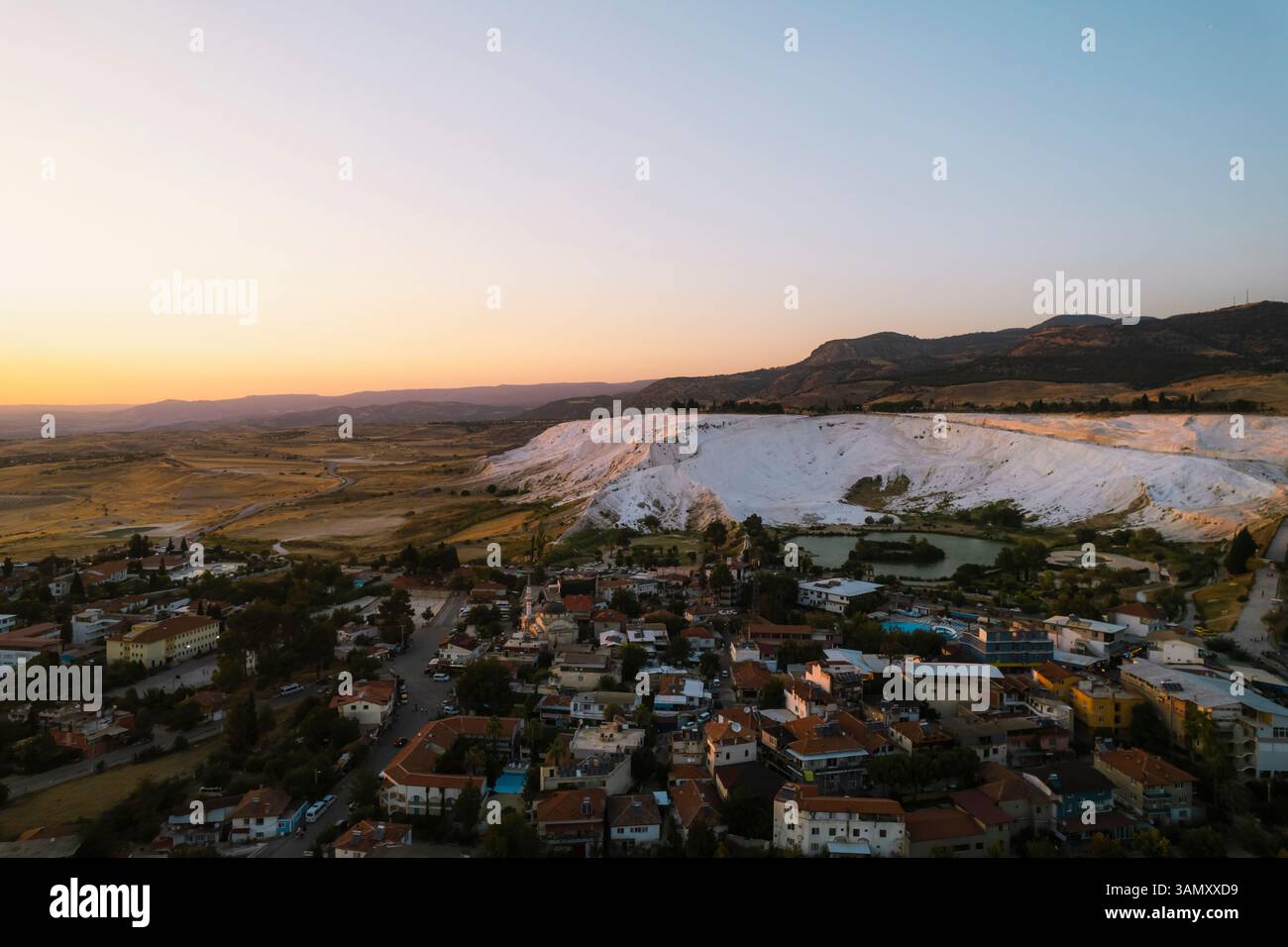 Aerial view of white cotton castle at sunset with beautiful travertine ...