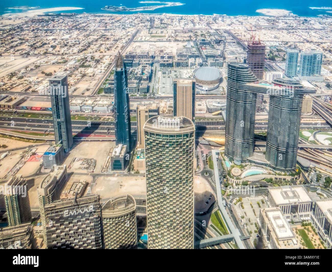 DUBAI, UAE. Aerial view over skyscrapers and busy road junction from Burj Khalifa. Cityscape ...