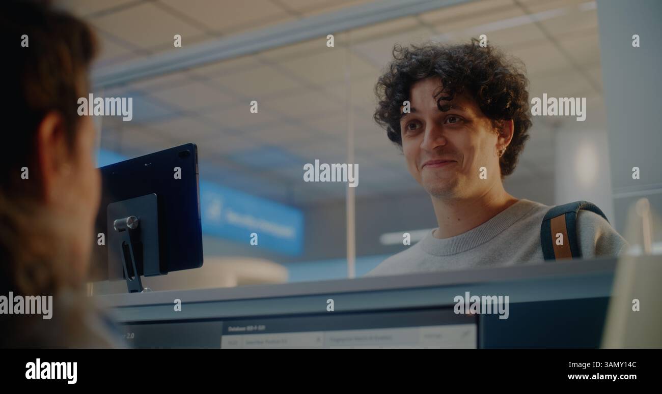 Young Man at Airport Check-in Counter: Female Airline Agent Checking ...