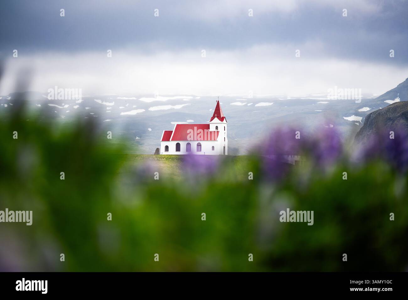 A lonely red-roofed church, Ingjaldshólskirkja, stands peacefully amid ...