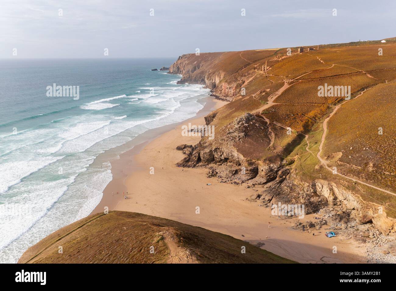 Aerial view of Chapel Porth beach with scenic cliffs and ocean waves ...
