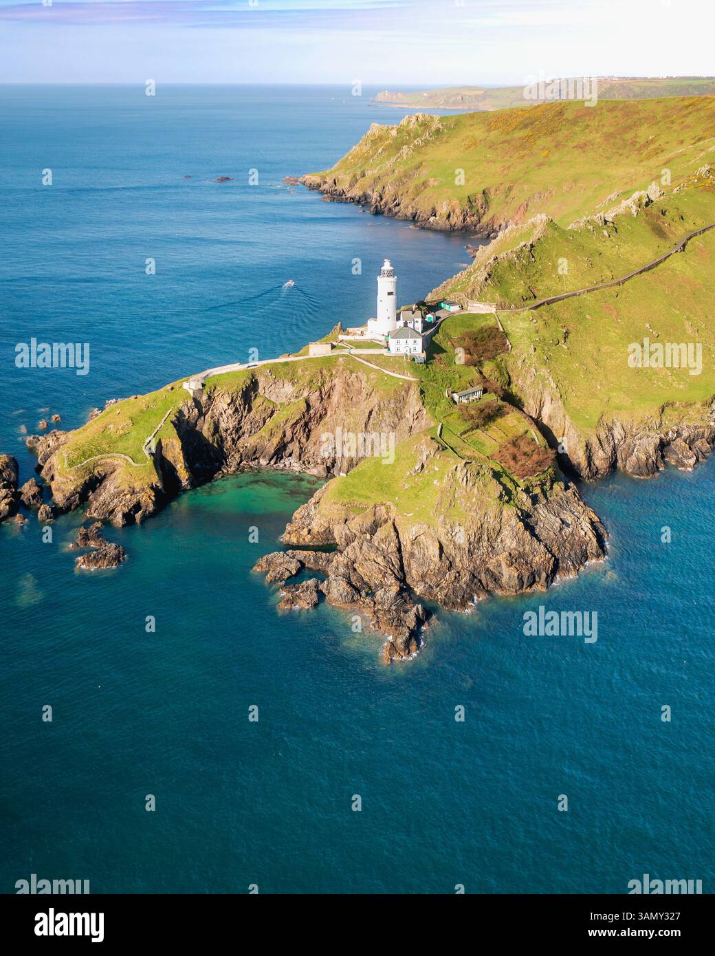 Aerial view of Start Point Lighthouse and rugged cliffs overlooking the ...