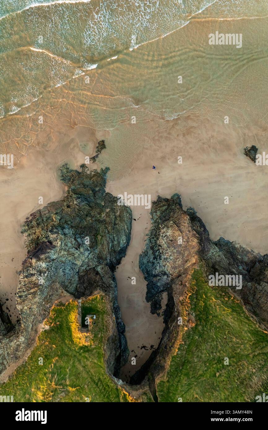 Aerial topdown view of Harbour cove beach and dog walker, with cliff ...