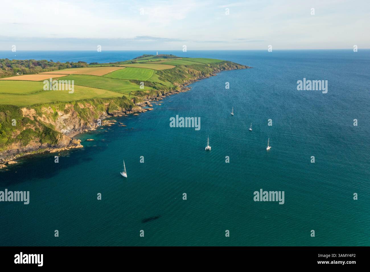 Aerial view of Yacht anchored in Polkerris harbour with view of harbour ...