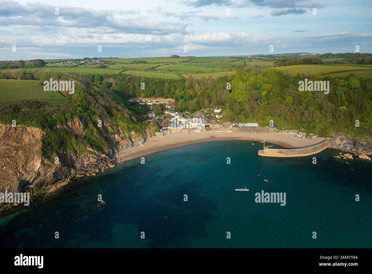 Aerial view of Yacht anchored in Polkerris harbour with view of harbour ...