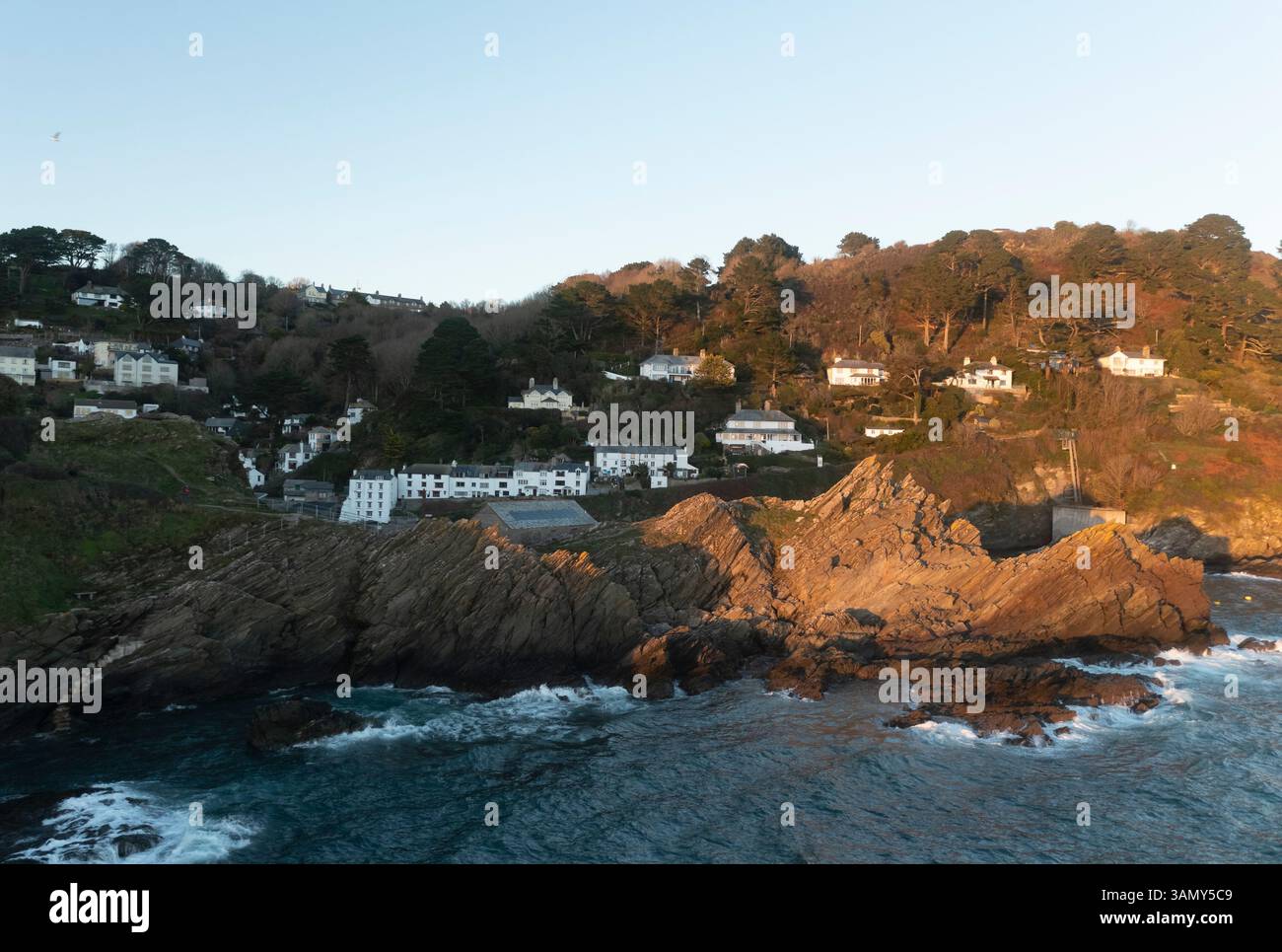 Aerial view of Polperro harbour and village at sunset, Cornwall, United ...