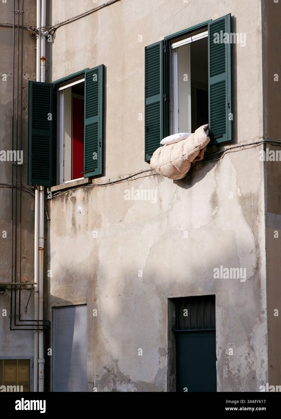 bedding hanging out of the window of an apartment building, Italy Stock ...
