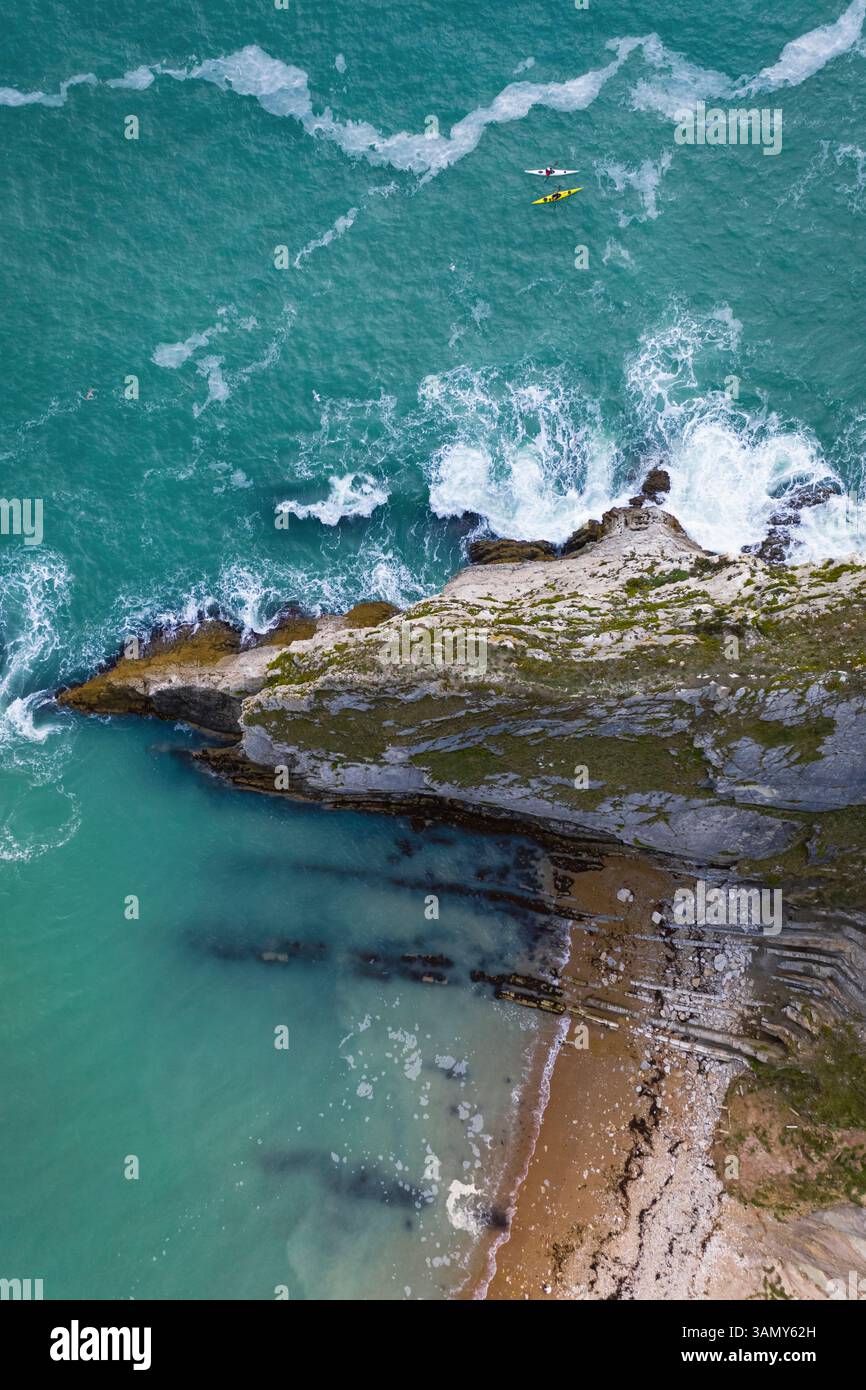 Aerial view of two people doing Kayak along the shoreline near Durdle ...