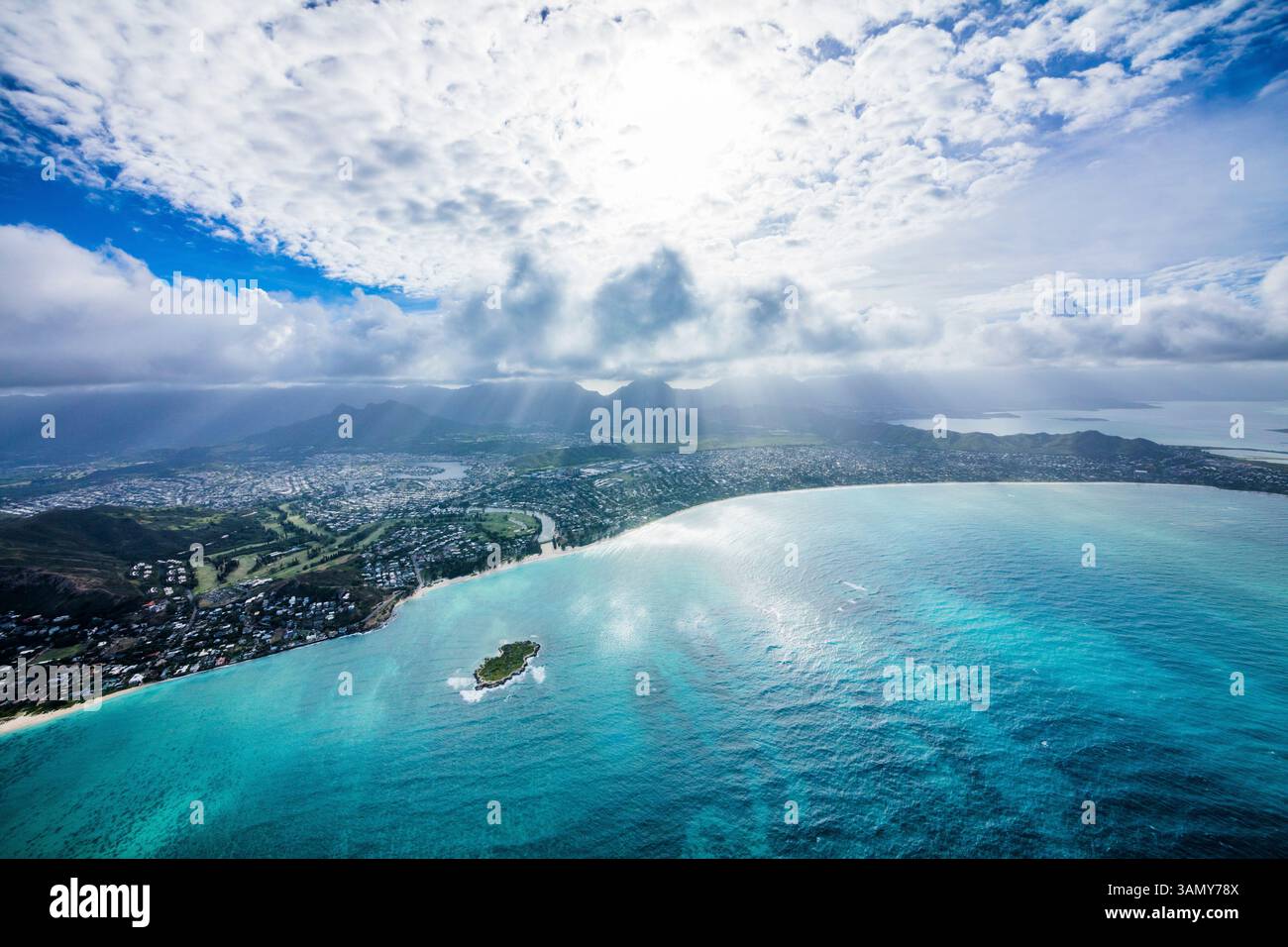 Aerial view of tropical paradise with turquoise waters and sun rays ...