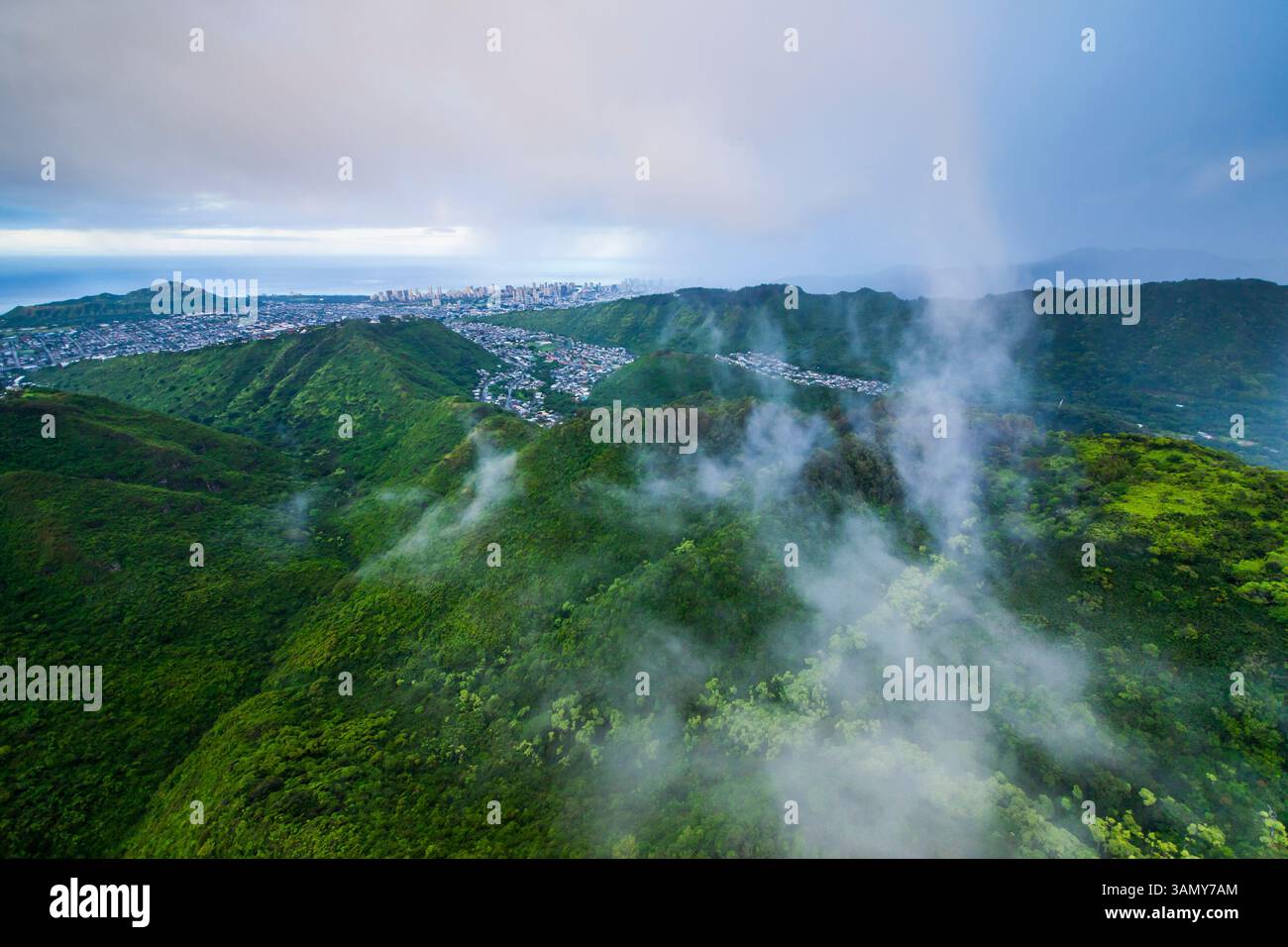 Aerial view of lush greenery and misty mountains in Palolo Spire Cloud ...