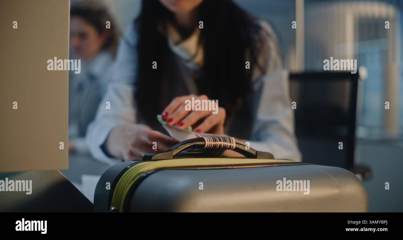 Airport Counter: Female Airline Check-in Attendant Putting Baggage Tag ...