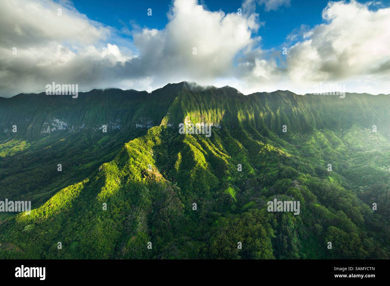 Aerial view of Olomana and Koolau Mountain Range with lush forest and ...