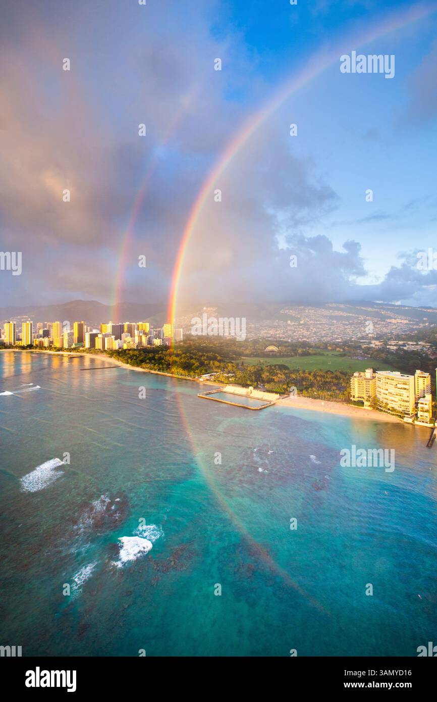 Aerial view of rainbow over Waikiki Beach and Honolulu cityscape ...