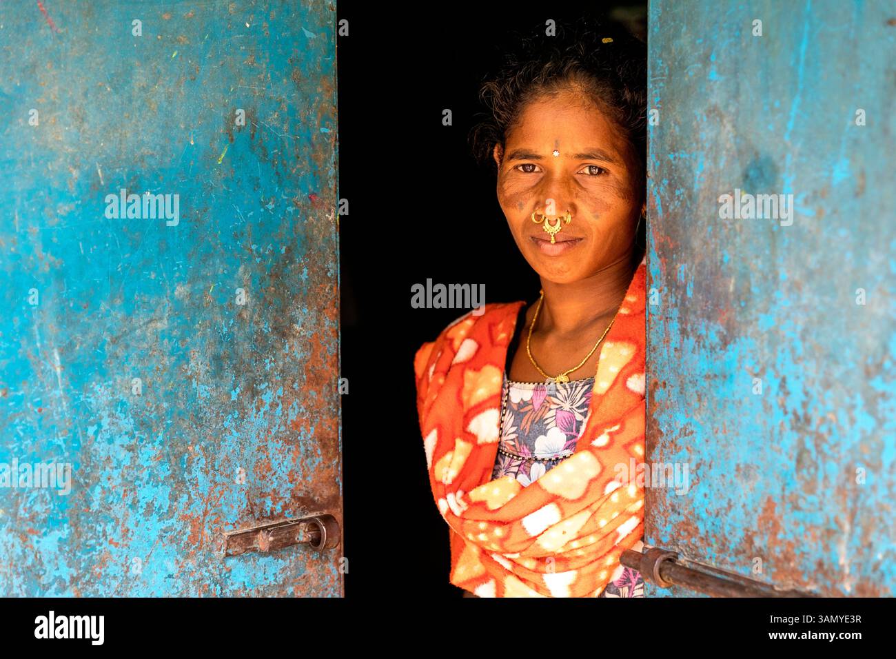 Portrait of a woman decorated with nose rings and jewelry standing by ...