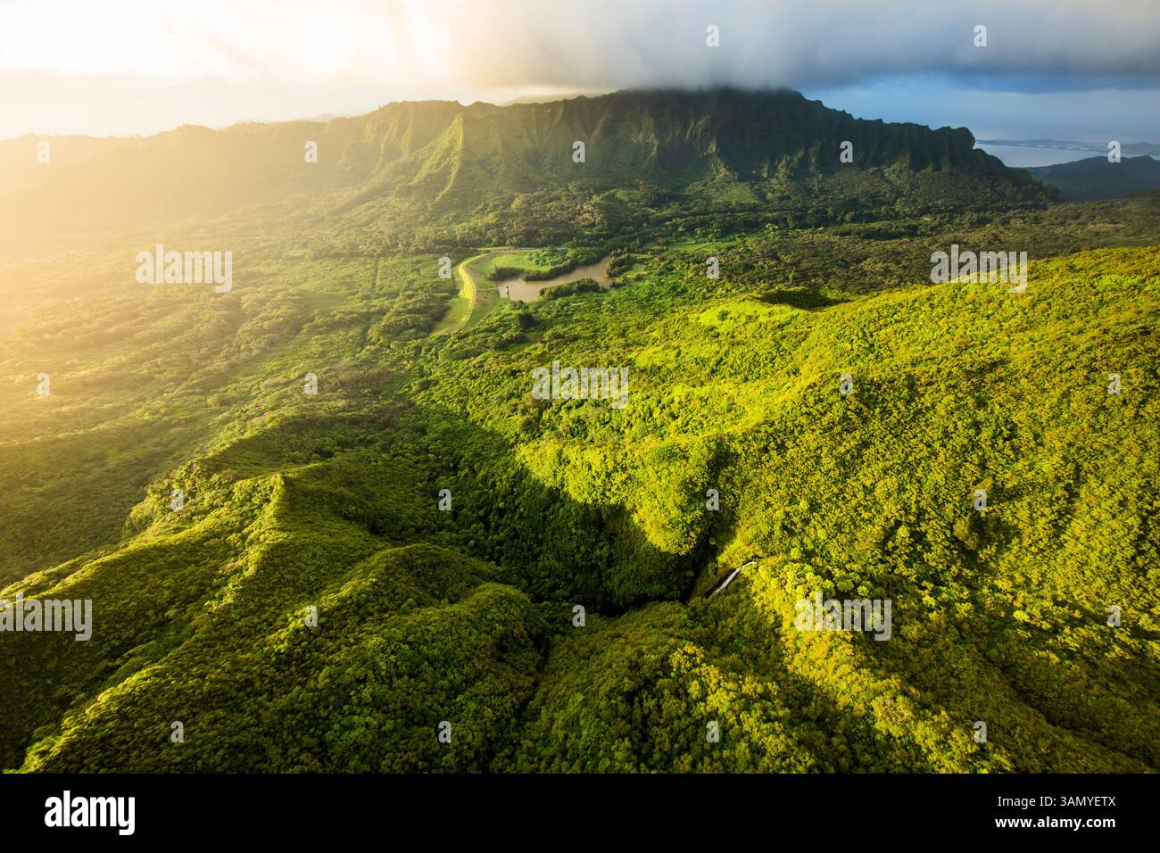 Aerial view of hidden waterfall in lush forest valley, Oahu, Hawaii ...