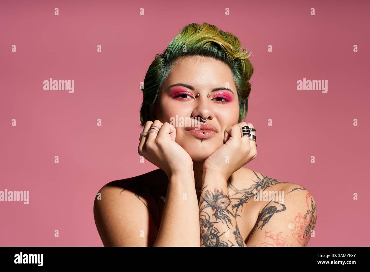 A confident young woman showcases bold makeup and stylish tattoos while ...