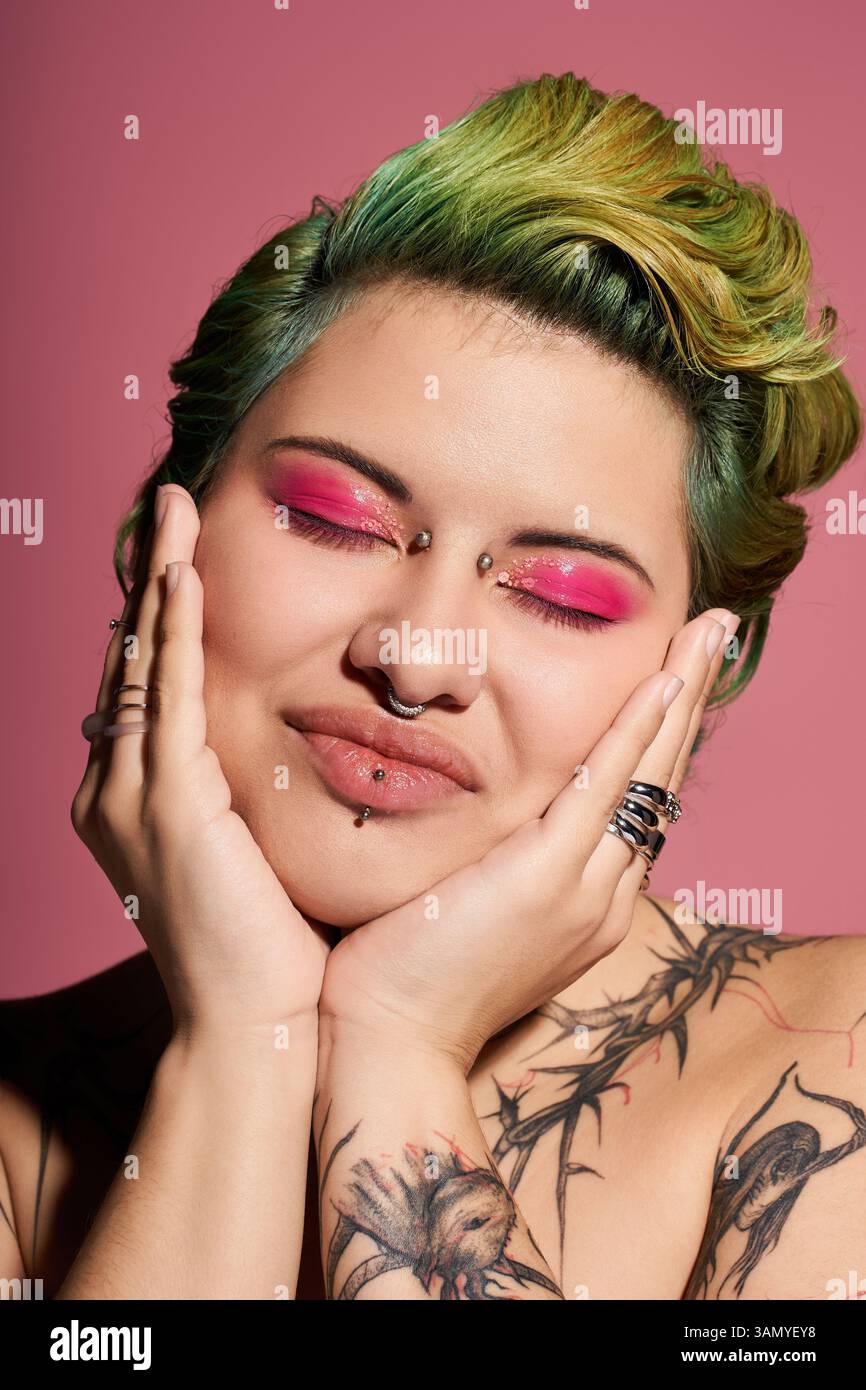 A confident woman with colorful hair and bold makeup poses elegantly ...