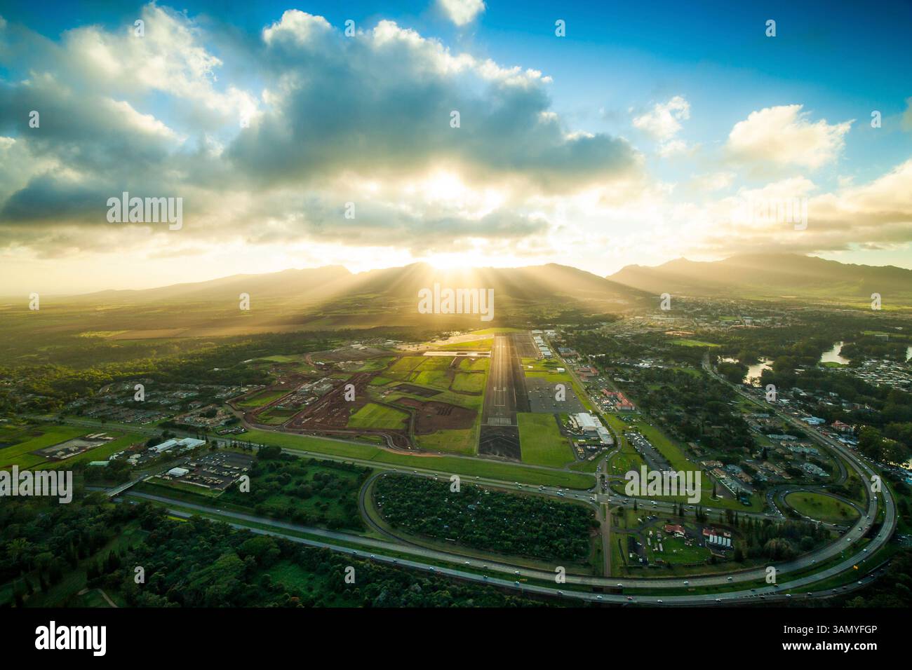 Aerial view of Wheeler landing strip with sunlight, clouds, fields ...