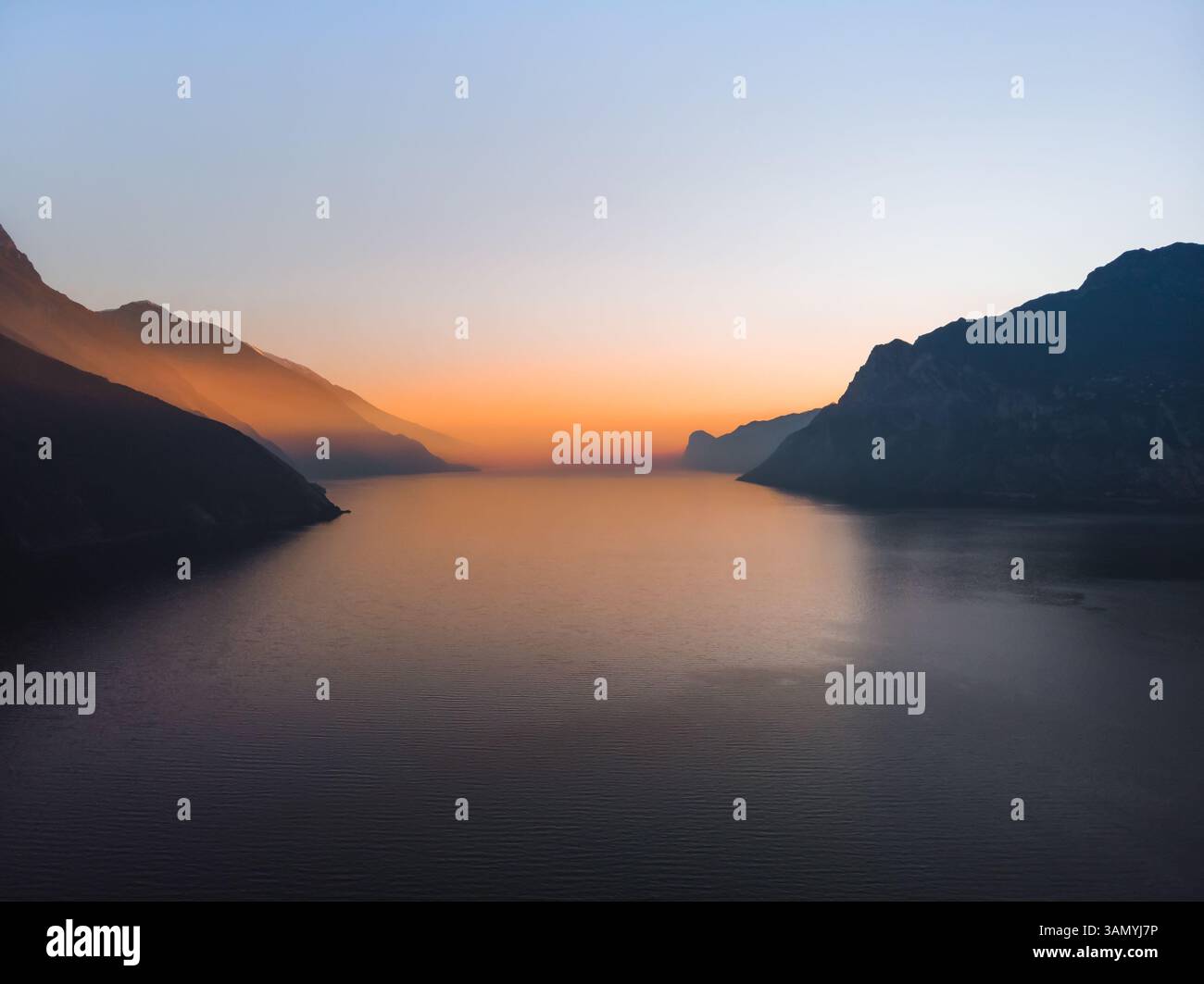 Aerial view of a foggy Lake Garda during sunset. Torbole, Trentino ...