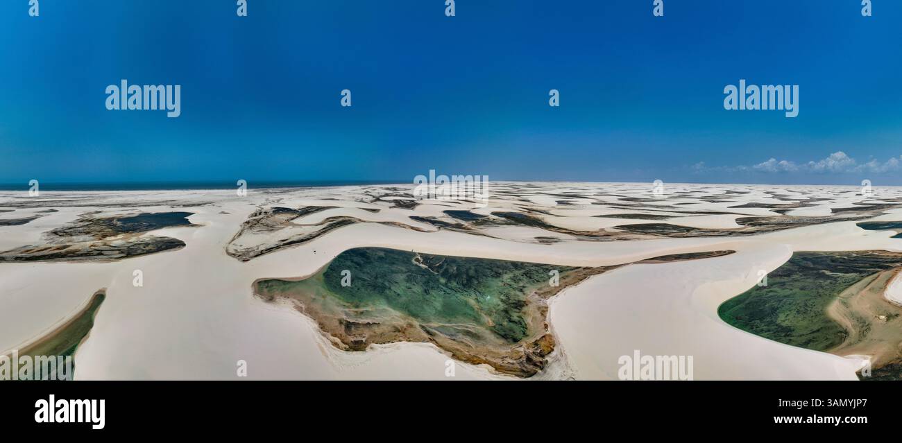 Aerial view of beautiful sand dunes and turquoise lagoons under a clear ...