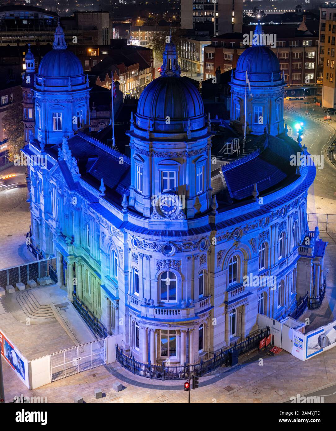 Aerial view of illuminated city hall and urban architecture at night ...