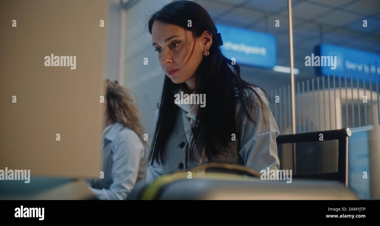 Airport Counter: Female Airline Check-in Attendant Putting Baggage Tag ...
