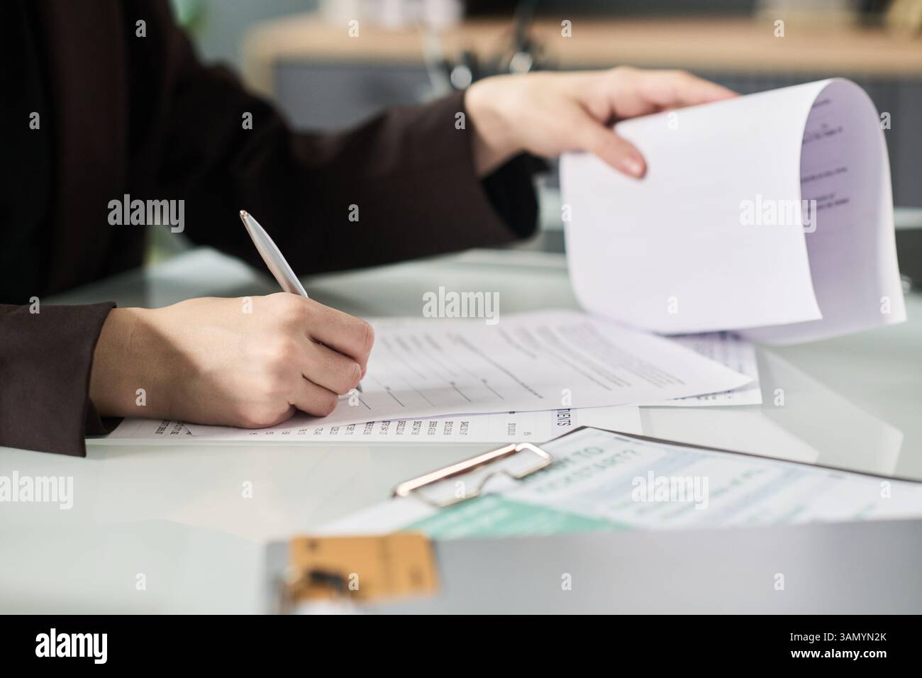 Woman signing document in office hi-res stock photography and images ...