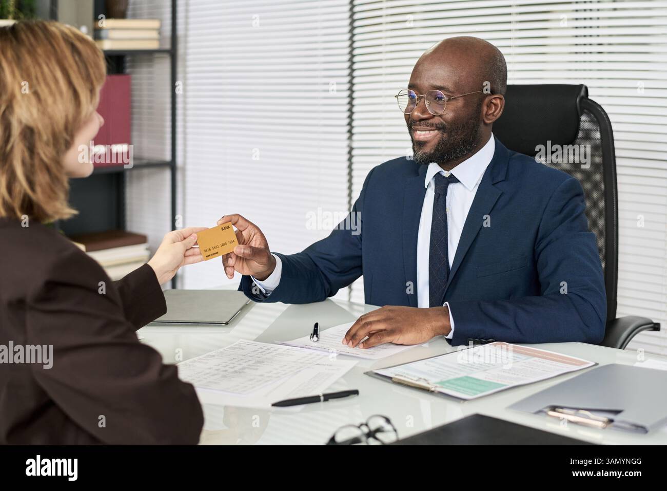 Caucasian woman giving document african hi-res stock photography and ...