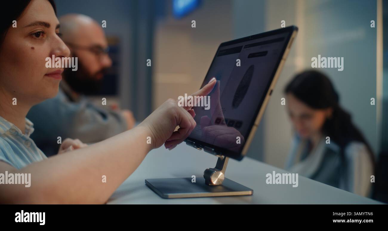 Passengers at Airport Check-in Counter: Side View of Woman Putting ...