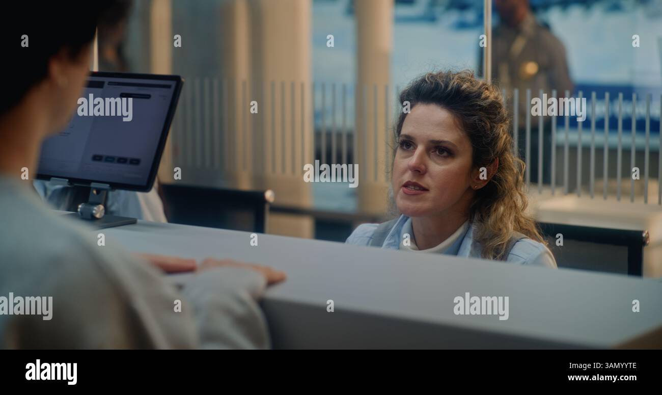 Airport Check-in Counter: Female Airline Check-in Attendant Talking to ...