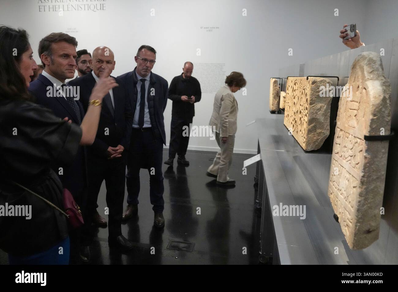 French President Emmanuel Macron, second left, listens to explanations ...