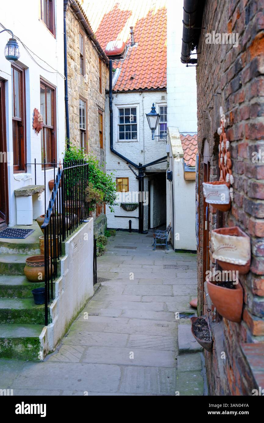 12 April 2025 - Whitby UK - A small istoric courtyard, alley way with ...