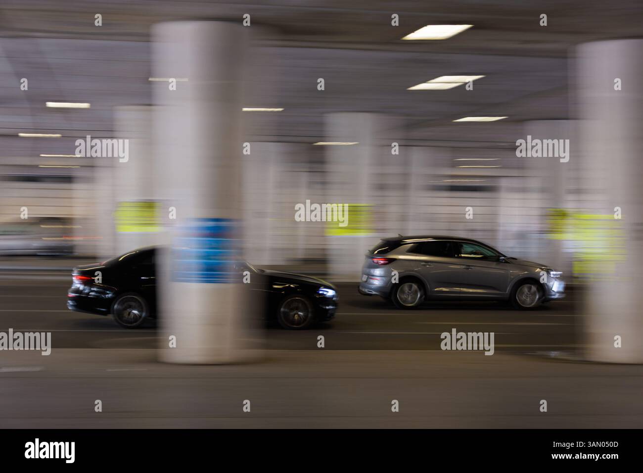 cars driving through an underpass during rush hour, blurred motion ...