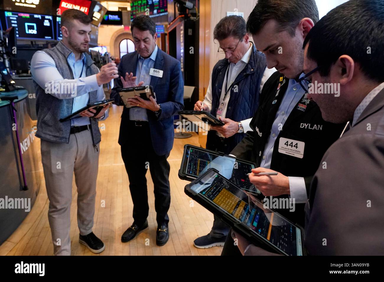 A group of traders work on the floor of the New York Stock Exchange ...