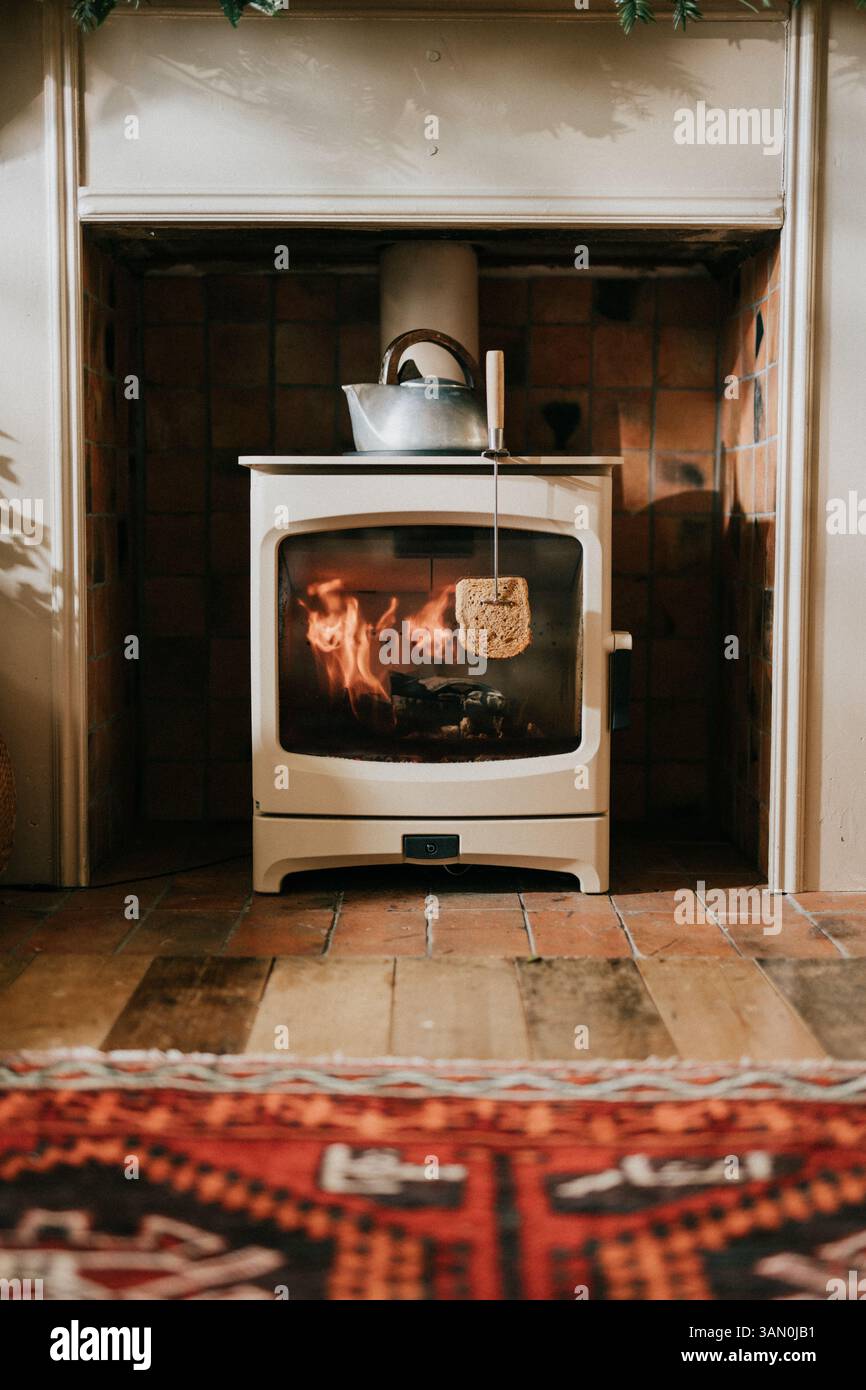 A white stove with a pot on top of it. The stove is in a room with a ...