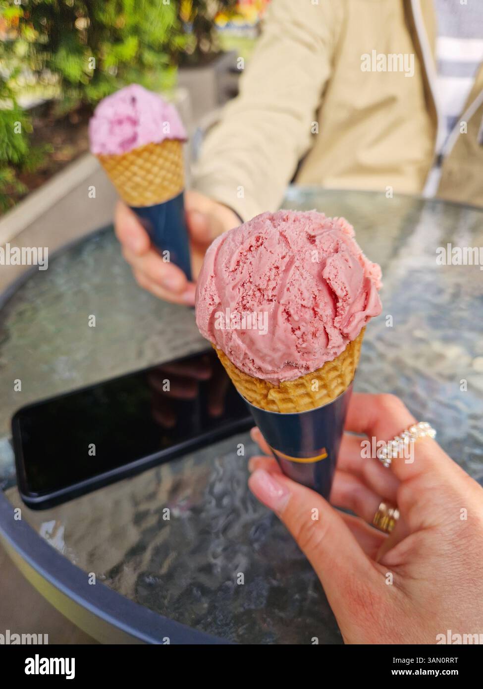 Two friends enjoying sunny day smartphone stock photos and images - Alamy