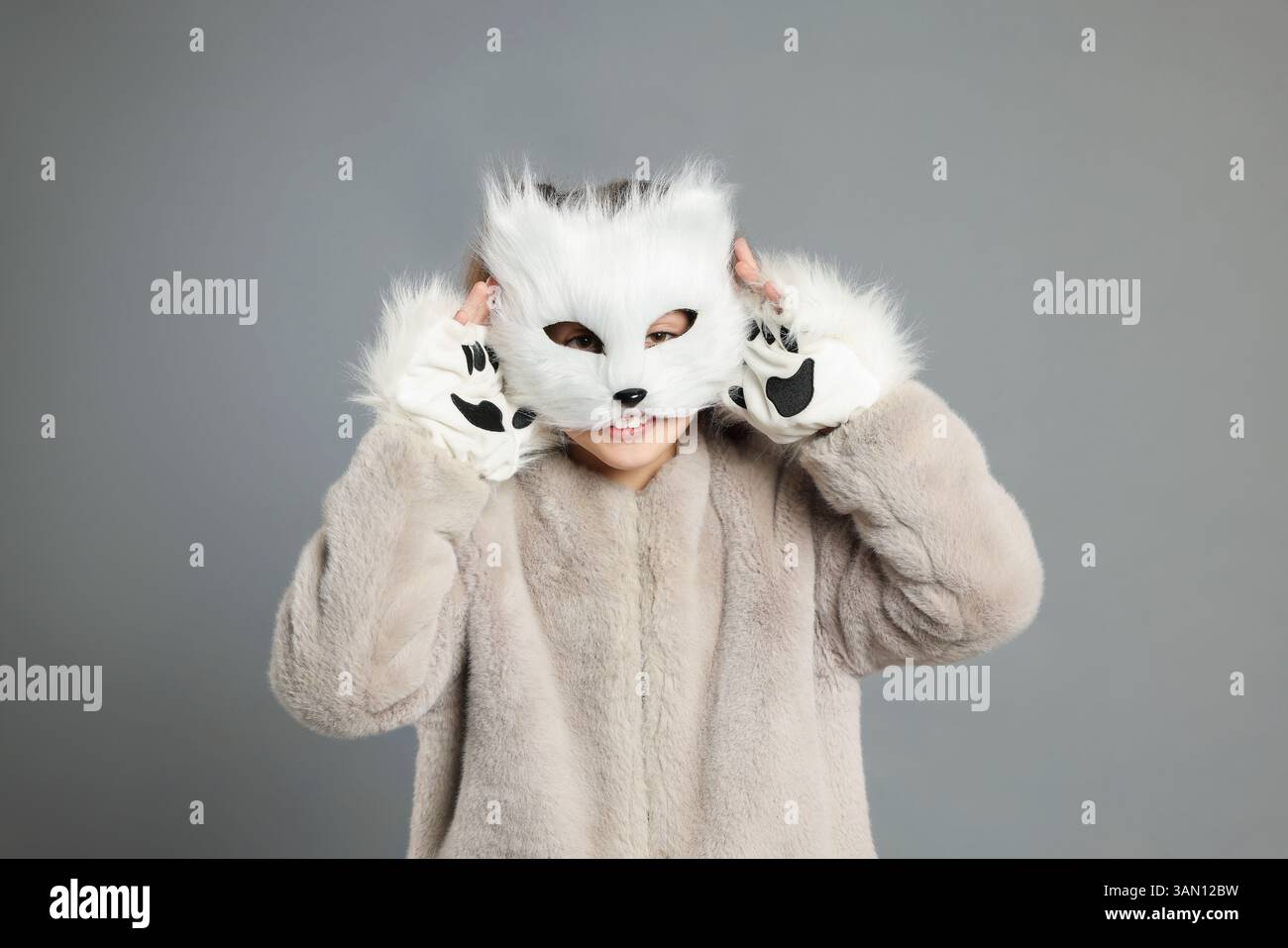Quadrobics. Girl wearing cat mask and gloves on grey background Stock ...
