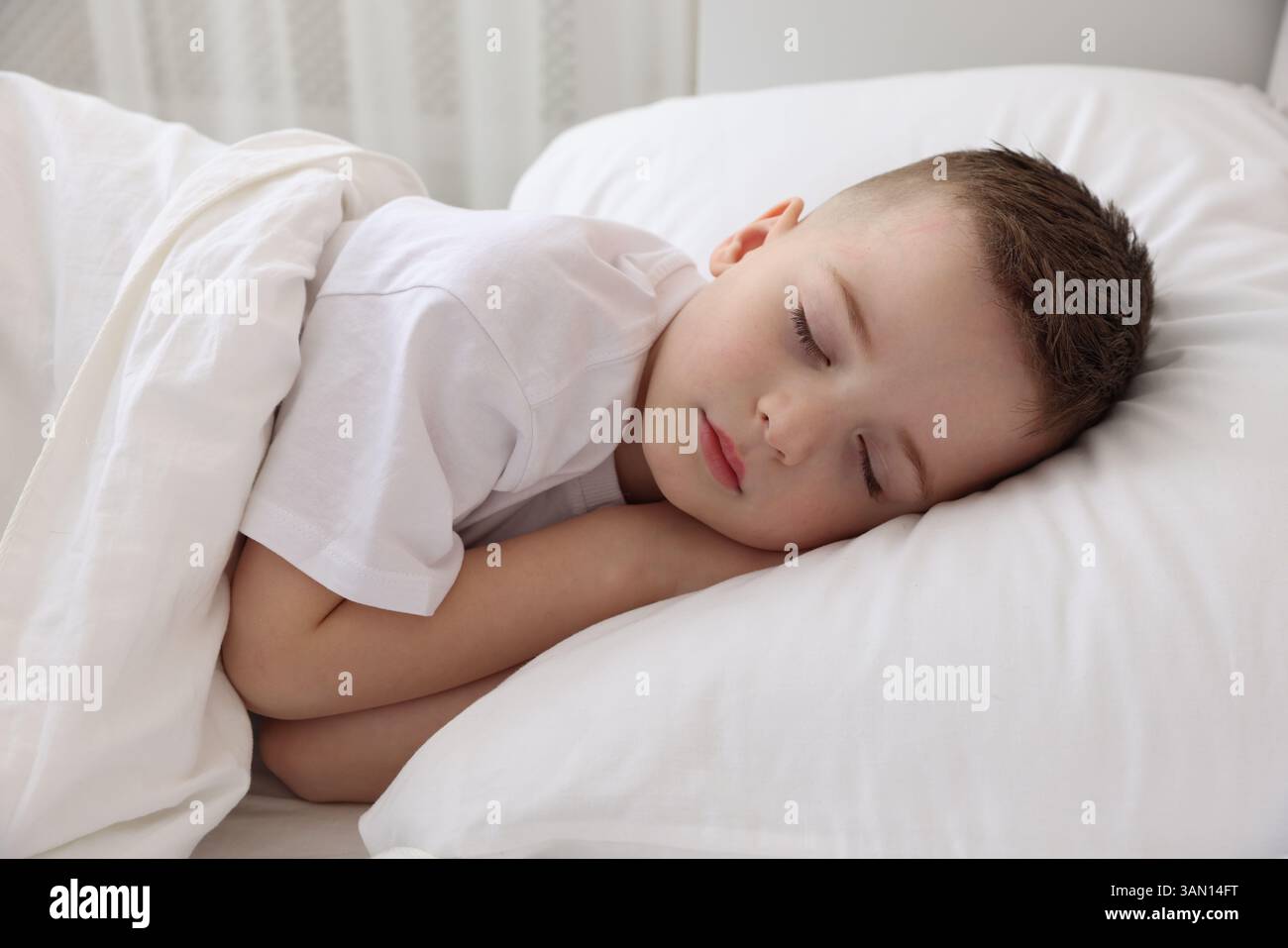 Bedtime. Cute boy sleeping in comfortable bed Stock Photo - Alamy