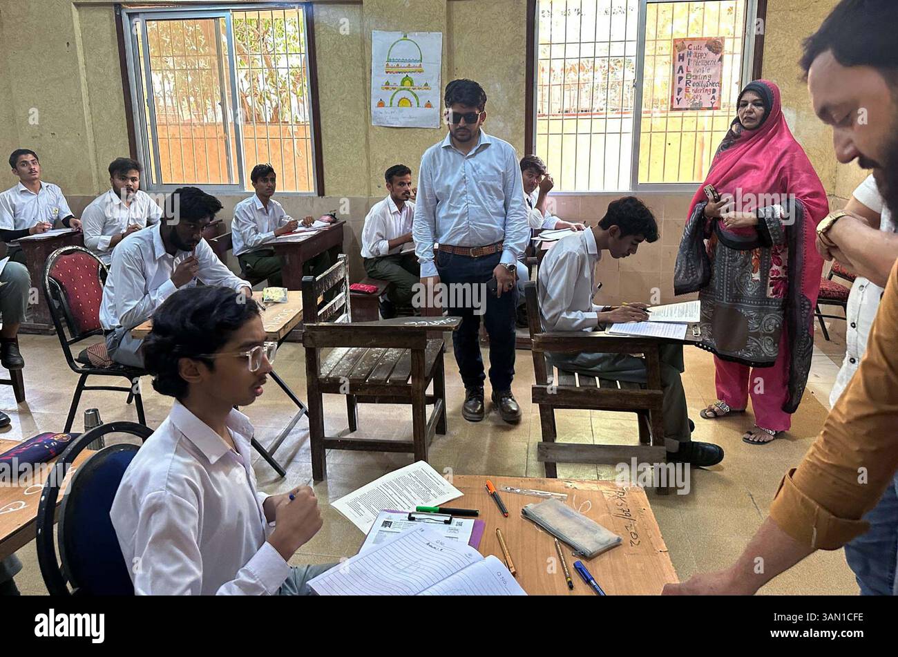 Students of matric class solving paper in examination center during ...