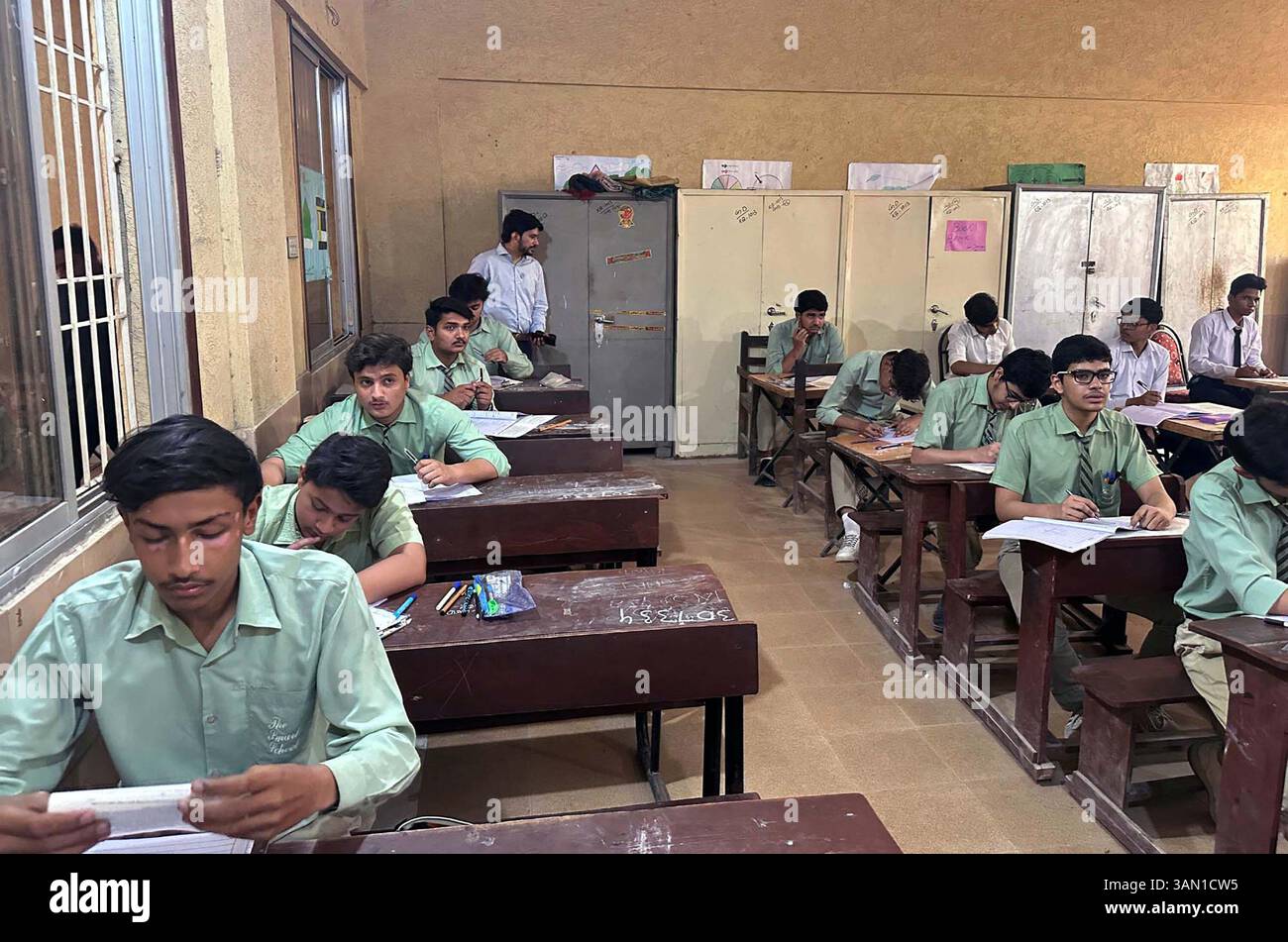 Students of matric class solving paper in examination center during ...