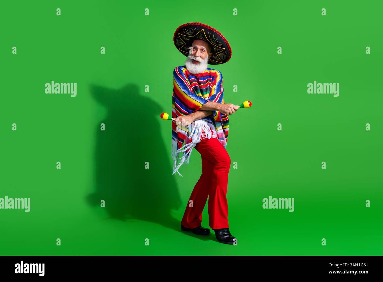 Charismatic mature man in traditional Mexican attire dancing with ...