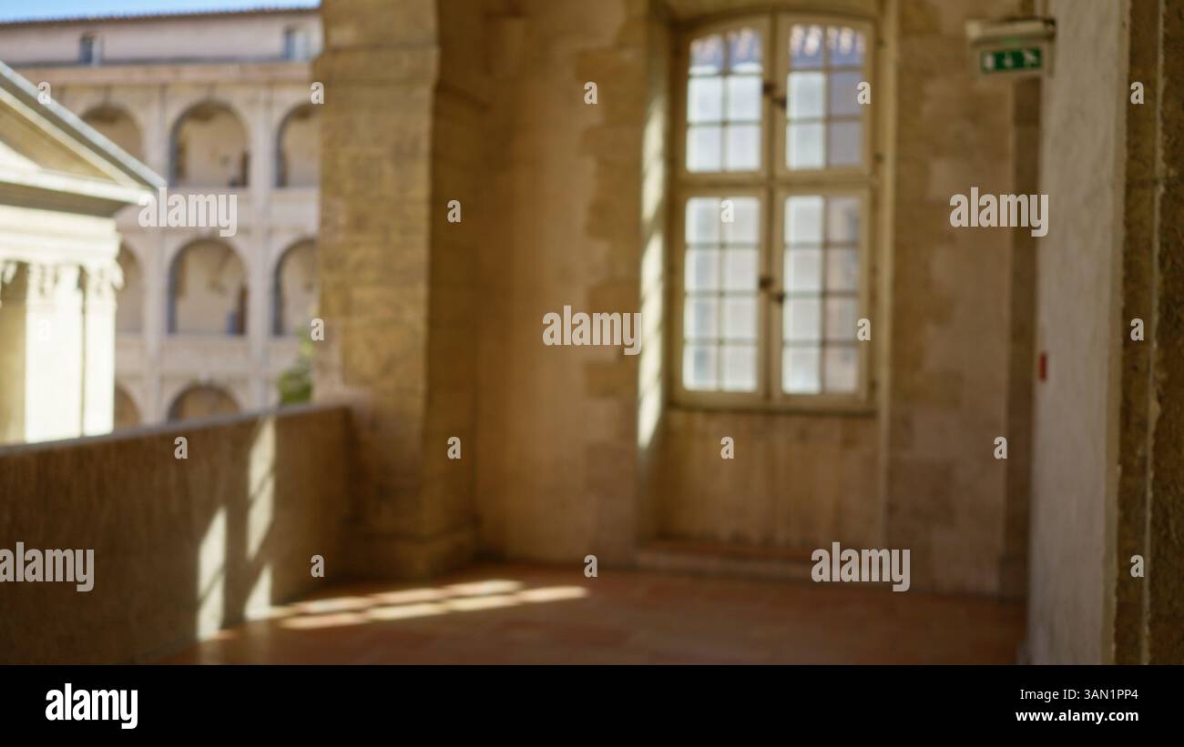 Defocused view of a historic university campus corridor with sunlight ...