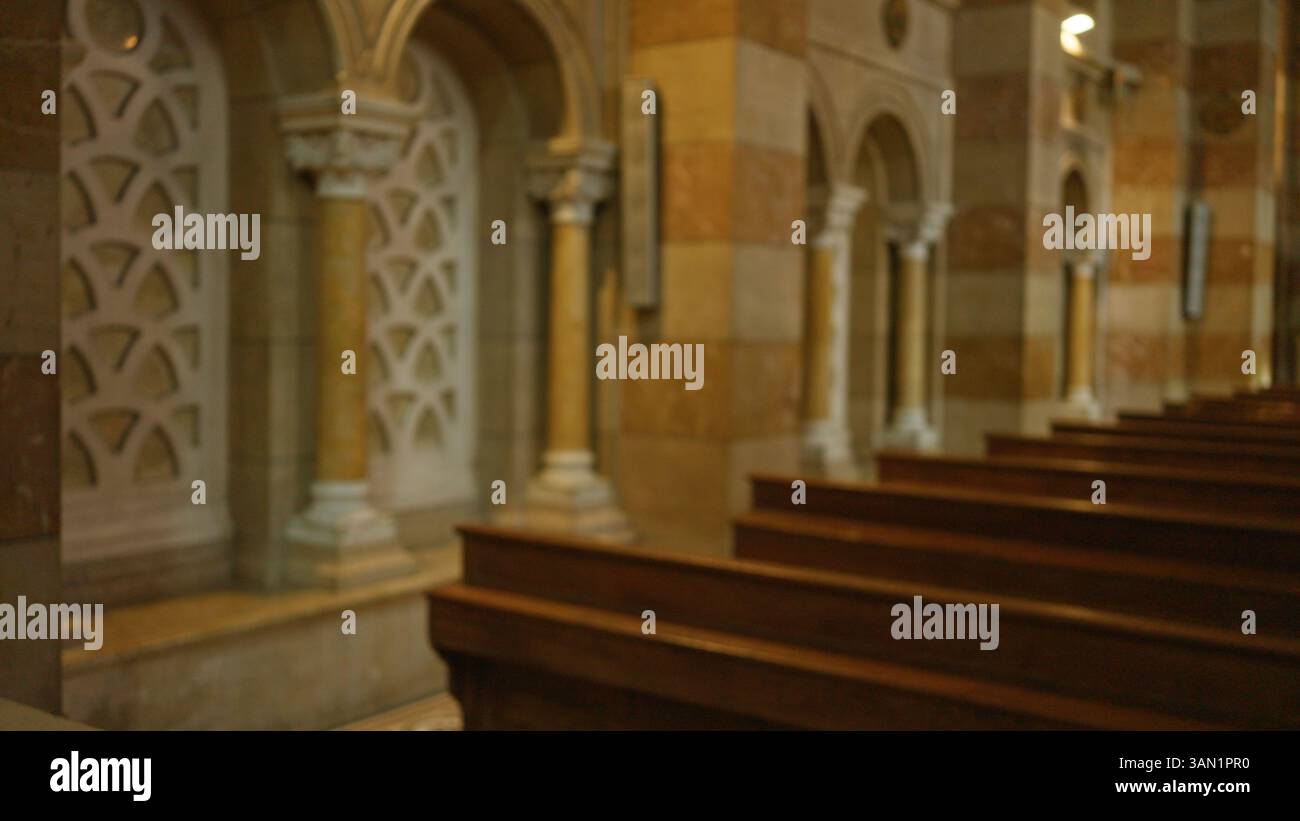 Blurred church interior with rows of wooden pews, showcasing intricate ...