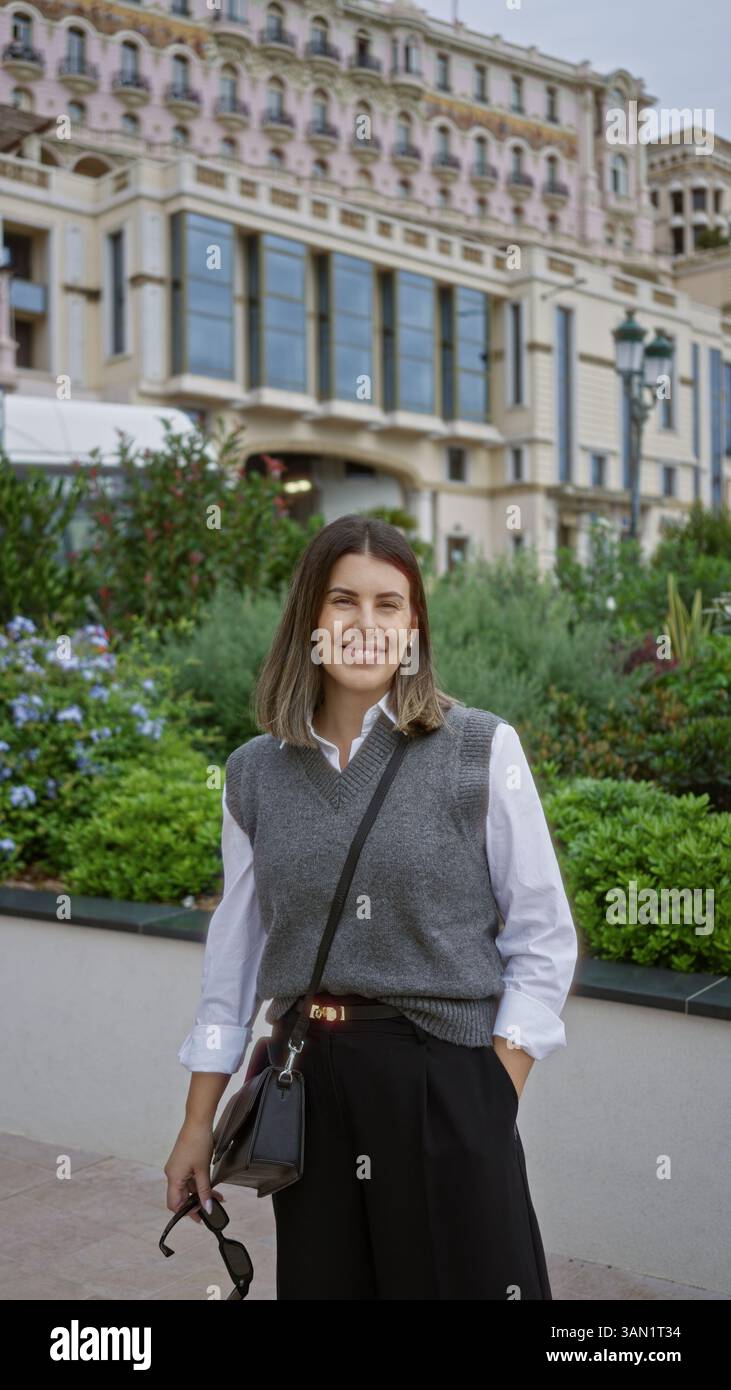 Woman smiling outdoors in monaco with elegant architecture backdrop ...