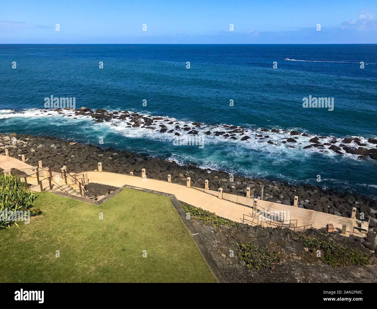 Waves roll onto the rugged coast as the ocean stretches to the horizon ...